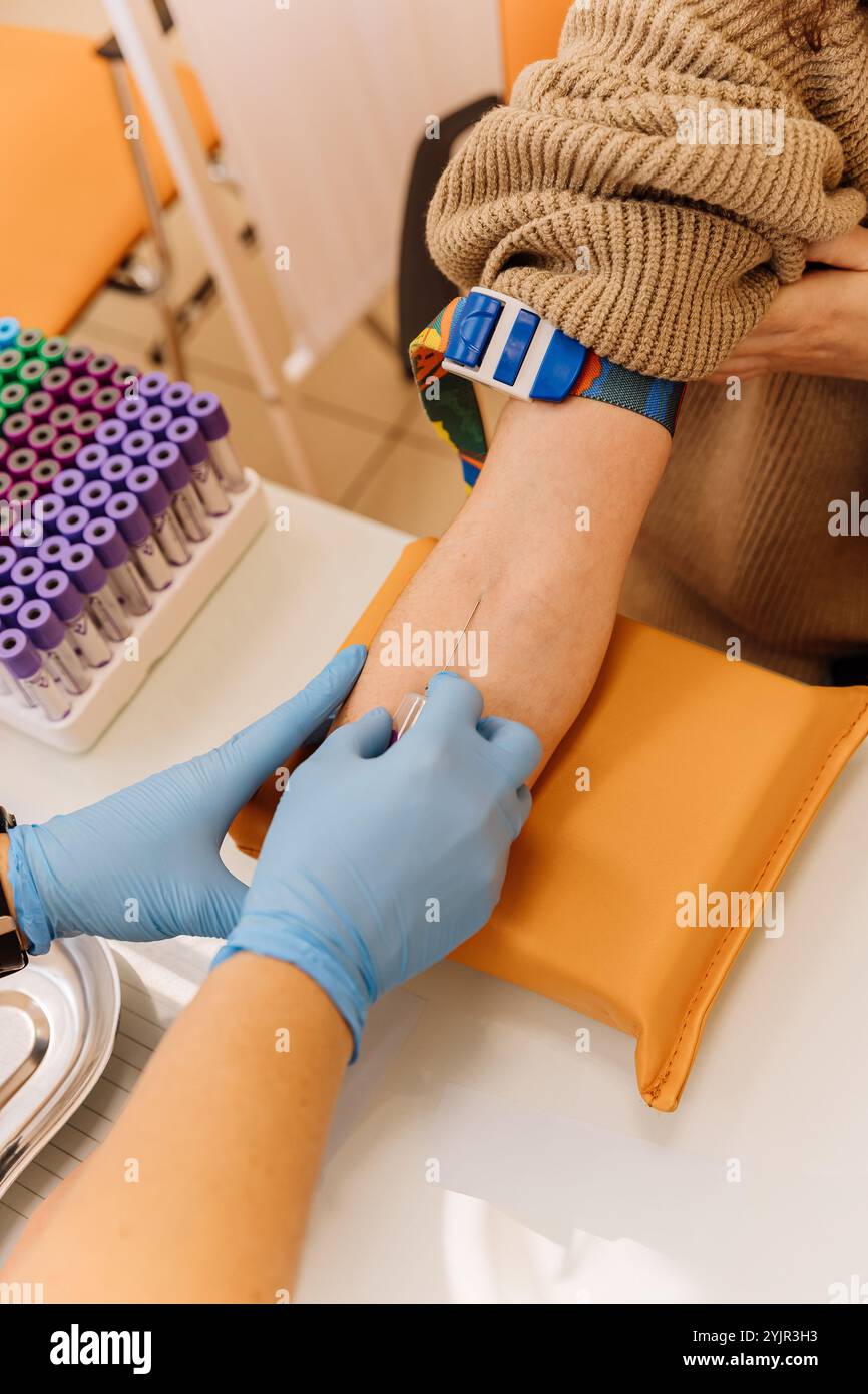 Medical professional performing blood draw procedure with precision in ...