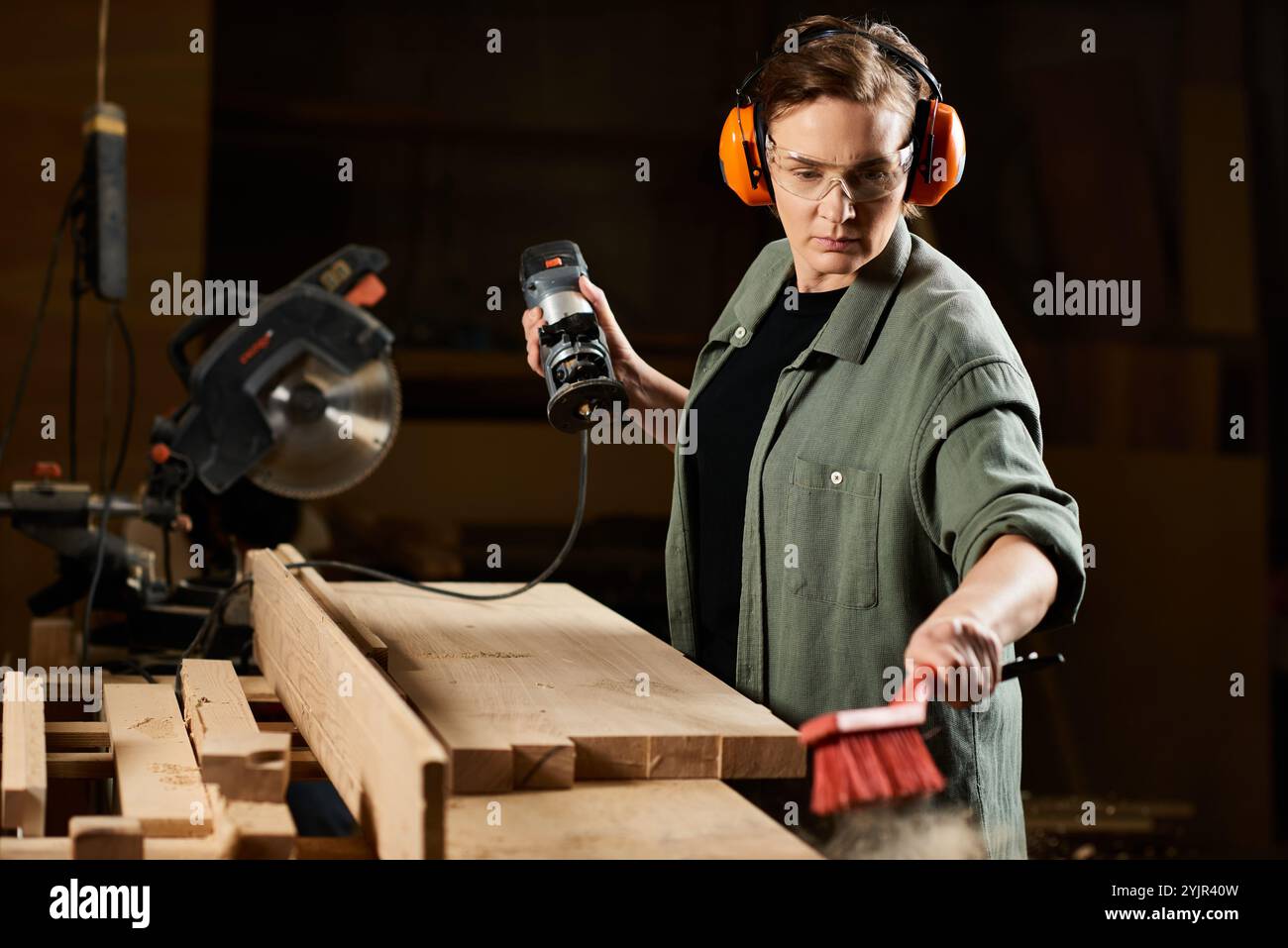 In her workshop, a talented female carpenter focuses on shaping wood ...