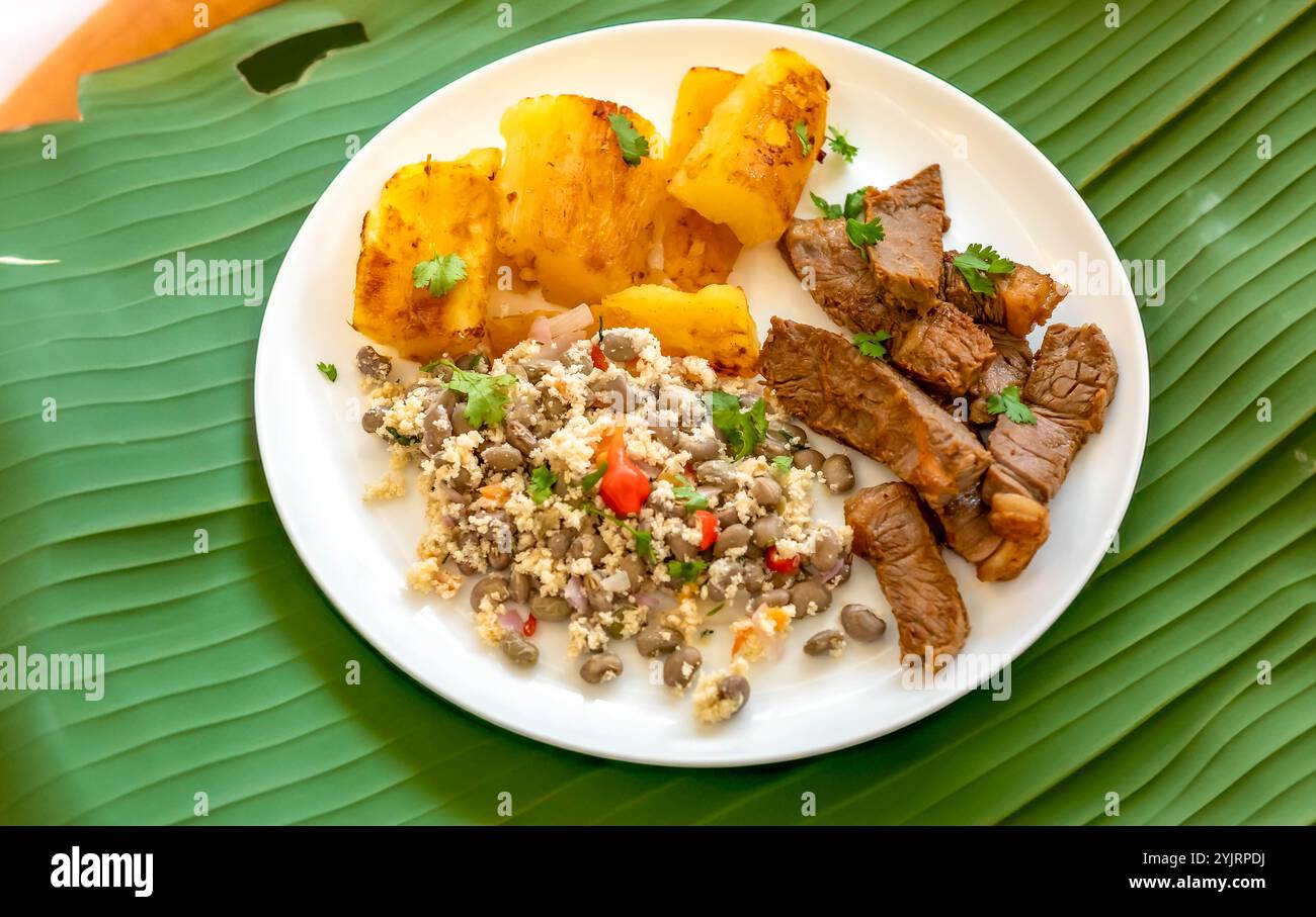 Traditional rustic tropical Brazilian dish, sun-dried beef with green ...