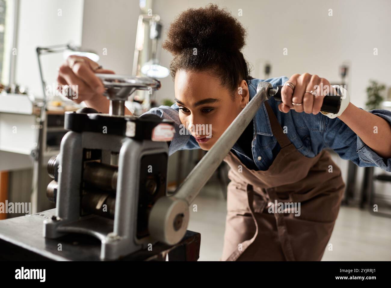 A talented woman focuses intently on her jewelry making process using ...