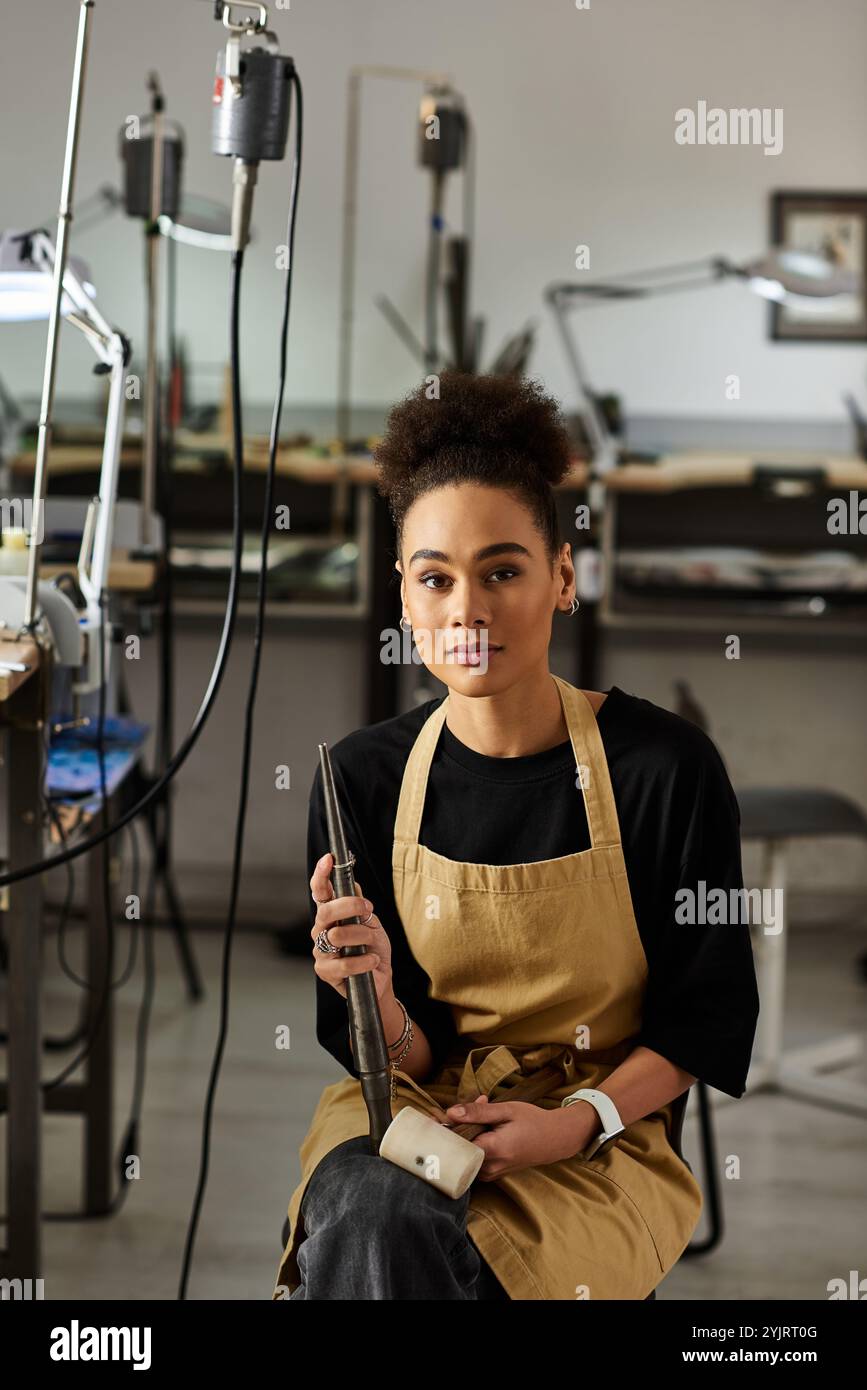 A talented woman works diligently in her jewelry making studio ...
