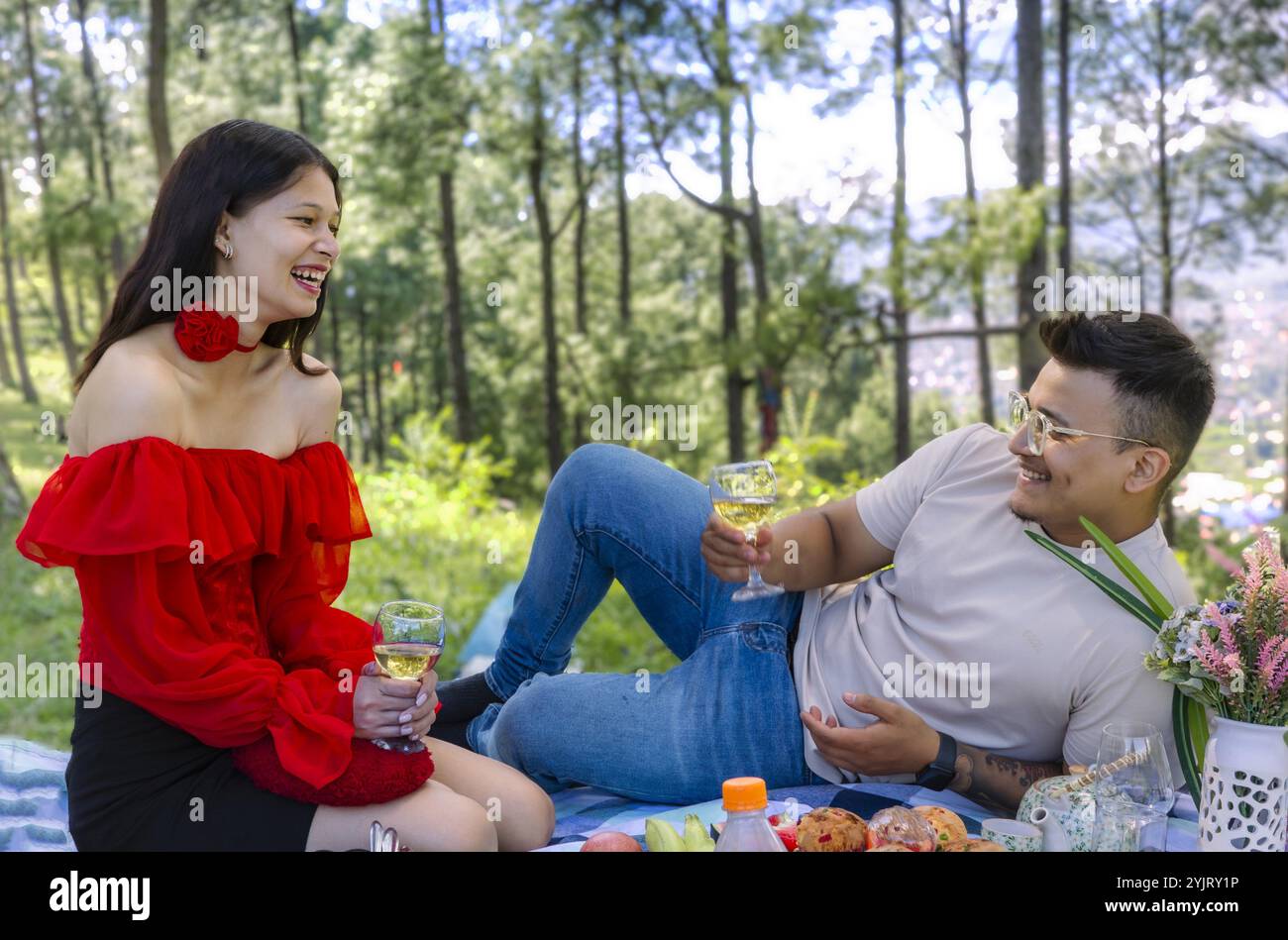 Romantic Couple out on a date in nature, picnic with food playing ...