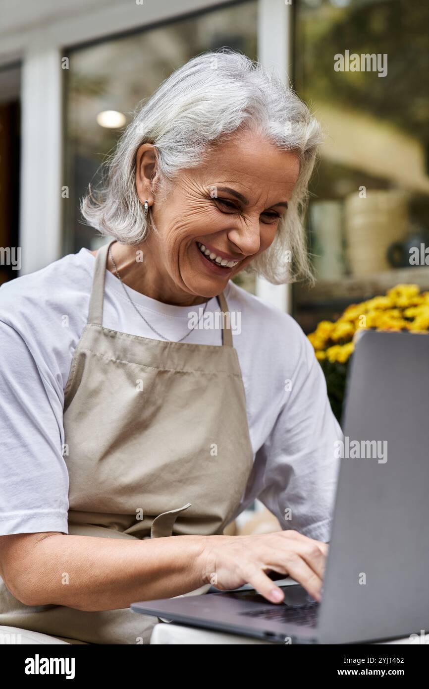Cheerful woman smiles she types hi-res stock photography and images - Alamy