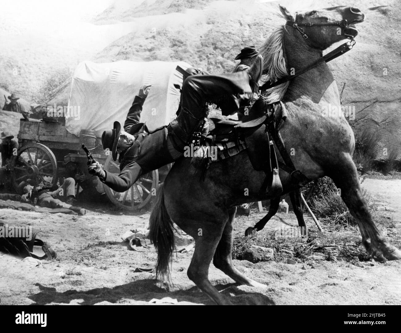 Cattle rustler being shot on horseback, on-set of the western film ...