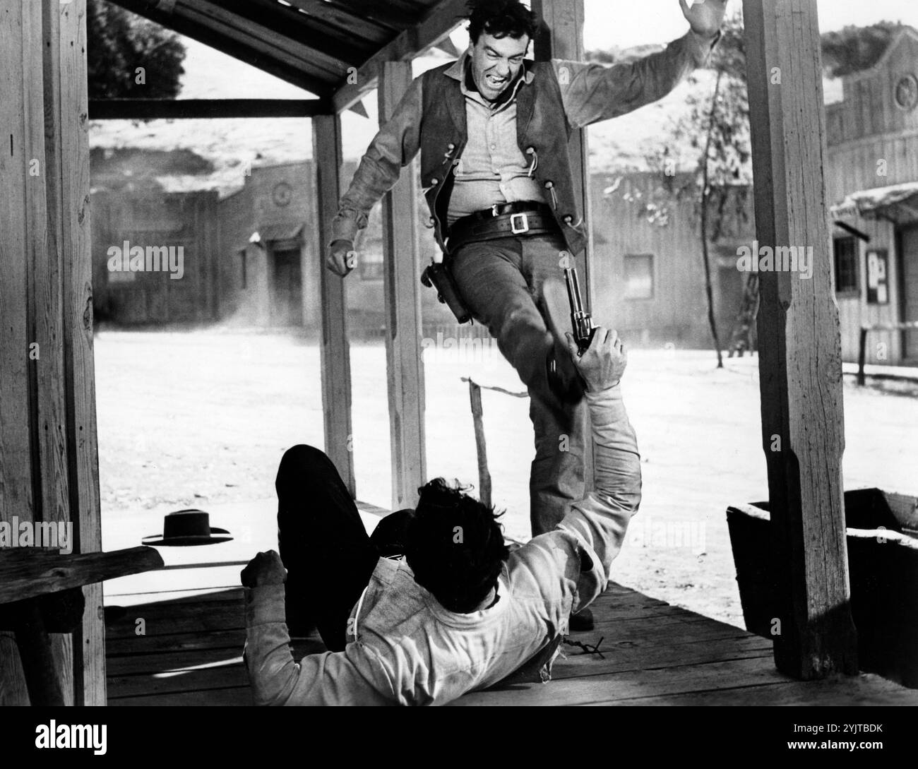 Don Megowan (laying on ground), James Arness, on-set of the western ...