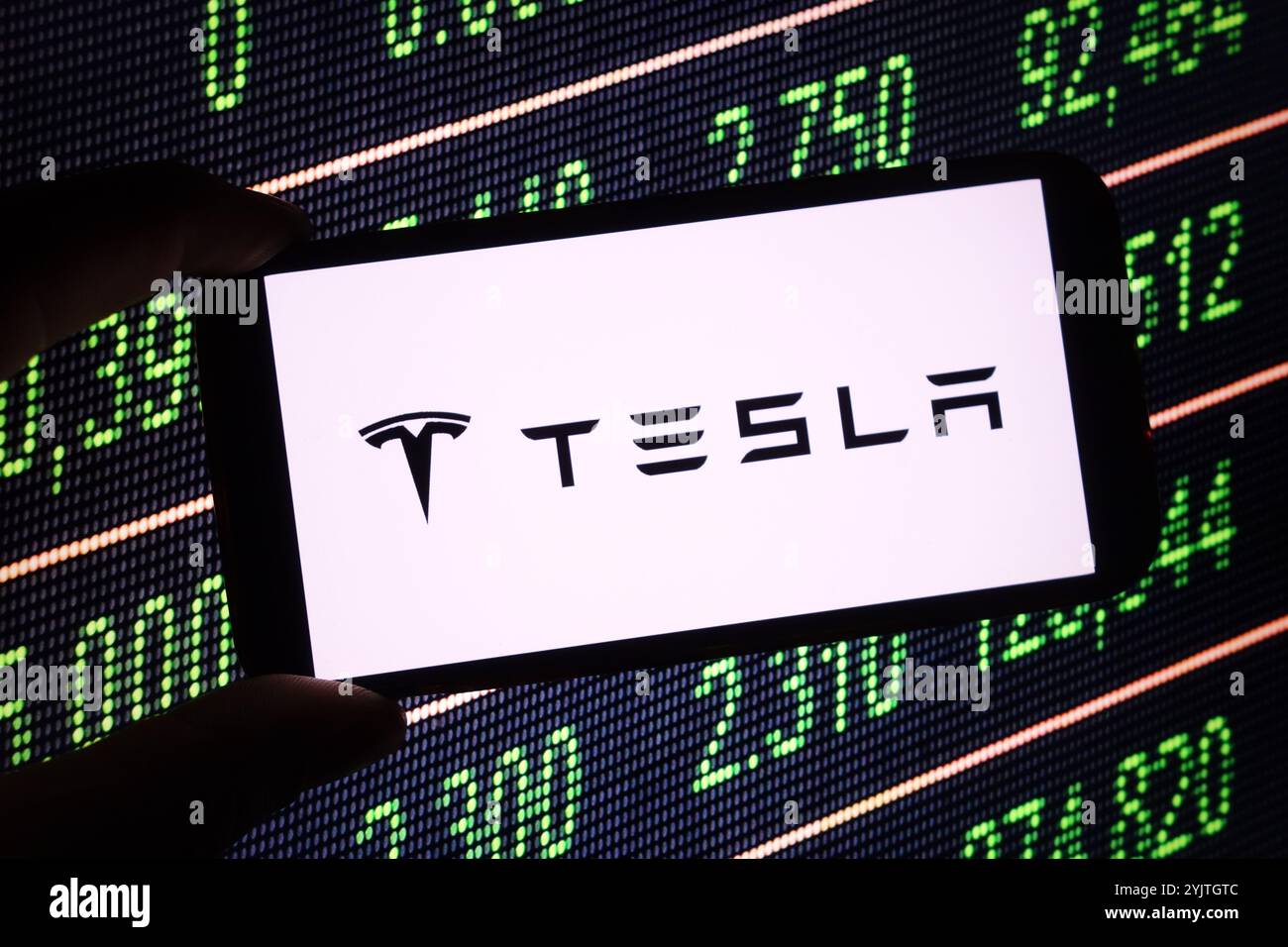 In this photo illustration, the Tesla company logo is seen displayed on ...