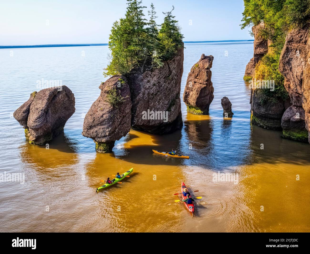 Kayakers at high tide around sea stacks in the Bay of Fundy at ...