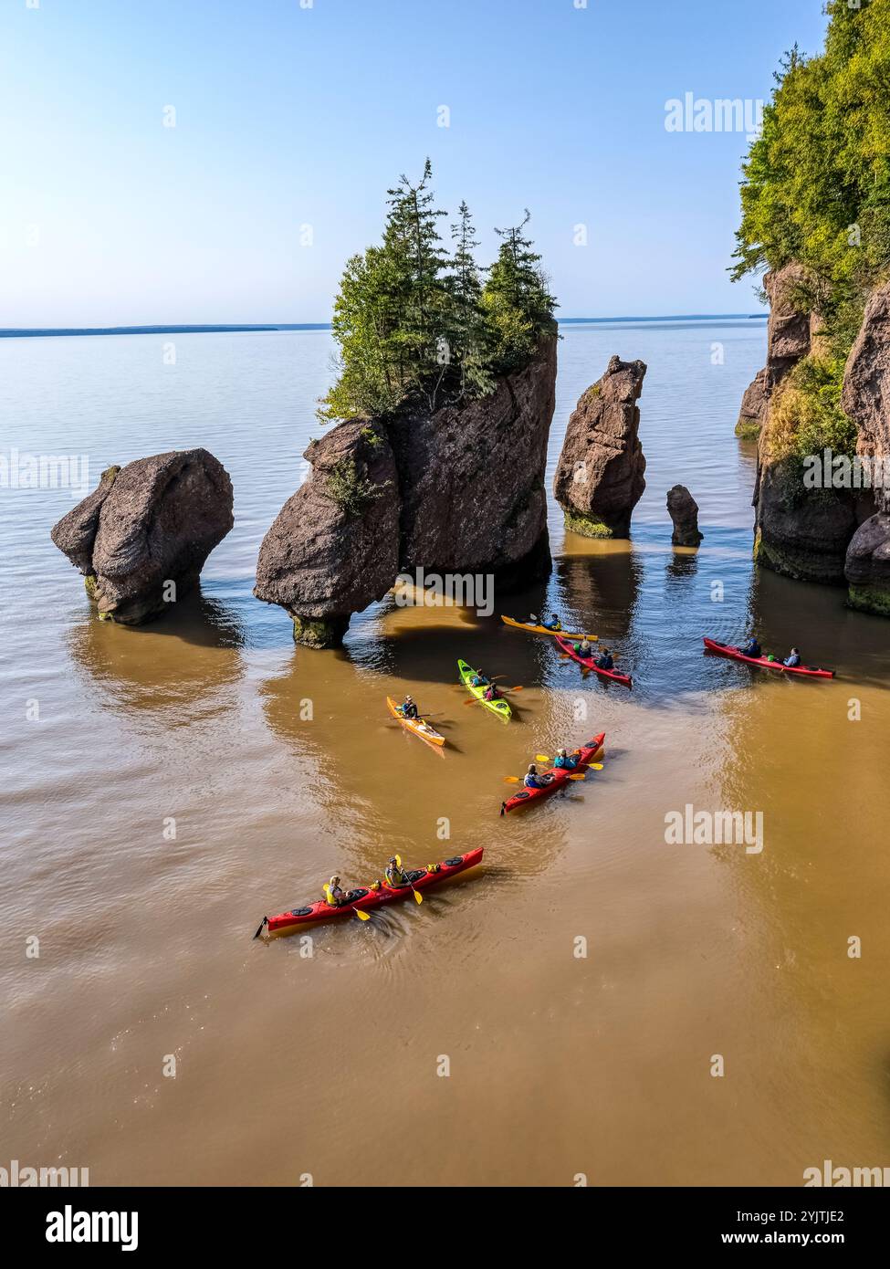 Kayakers at high tide around sea stacks in the Bay of Fundy at ...