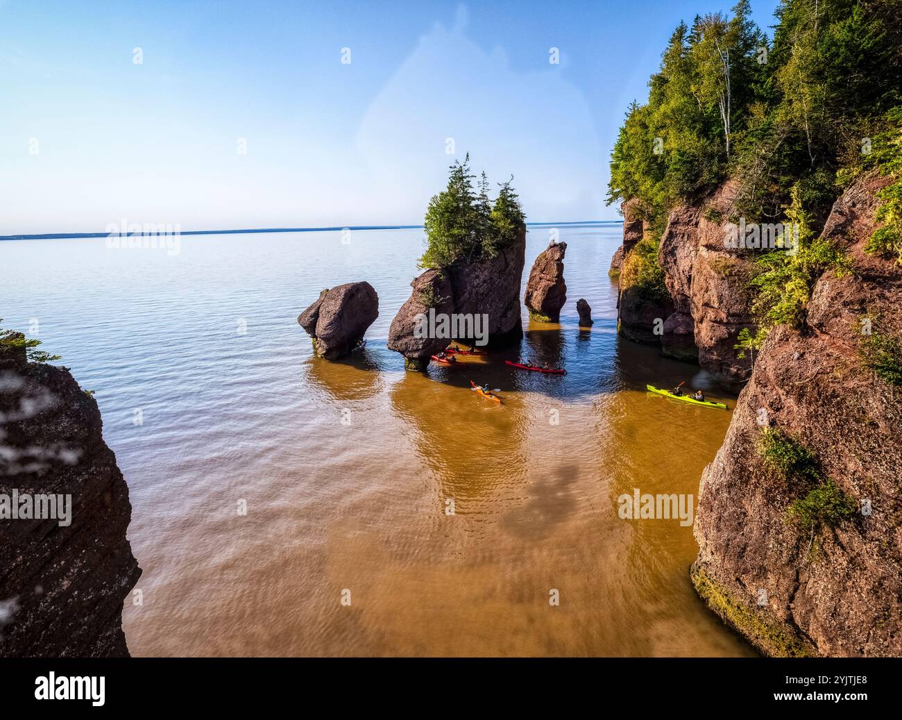 Kayakers at high tide around sea stacks in the Bay of Fundy at ...