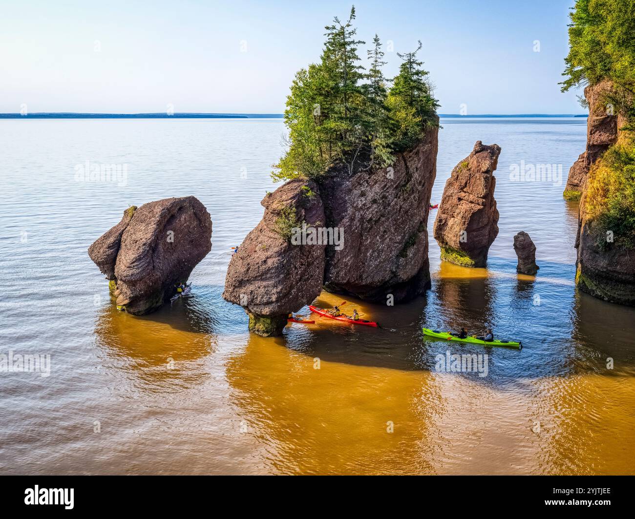 Kayakers at high tide around sea stacks in the Bay of Fundy at ...