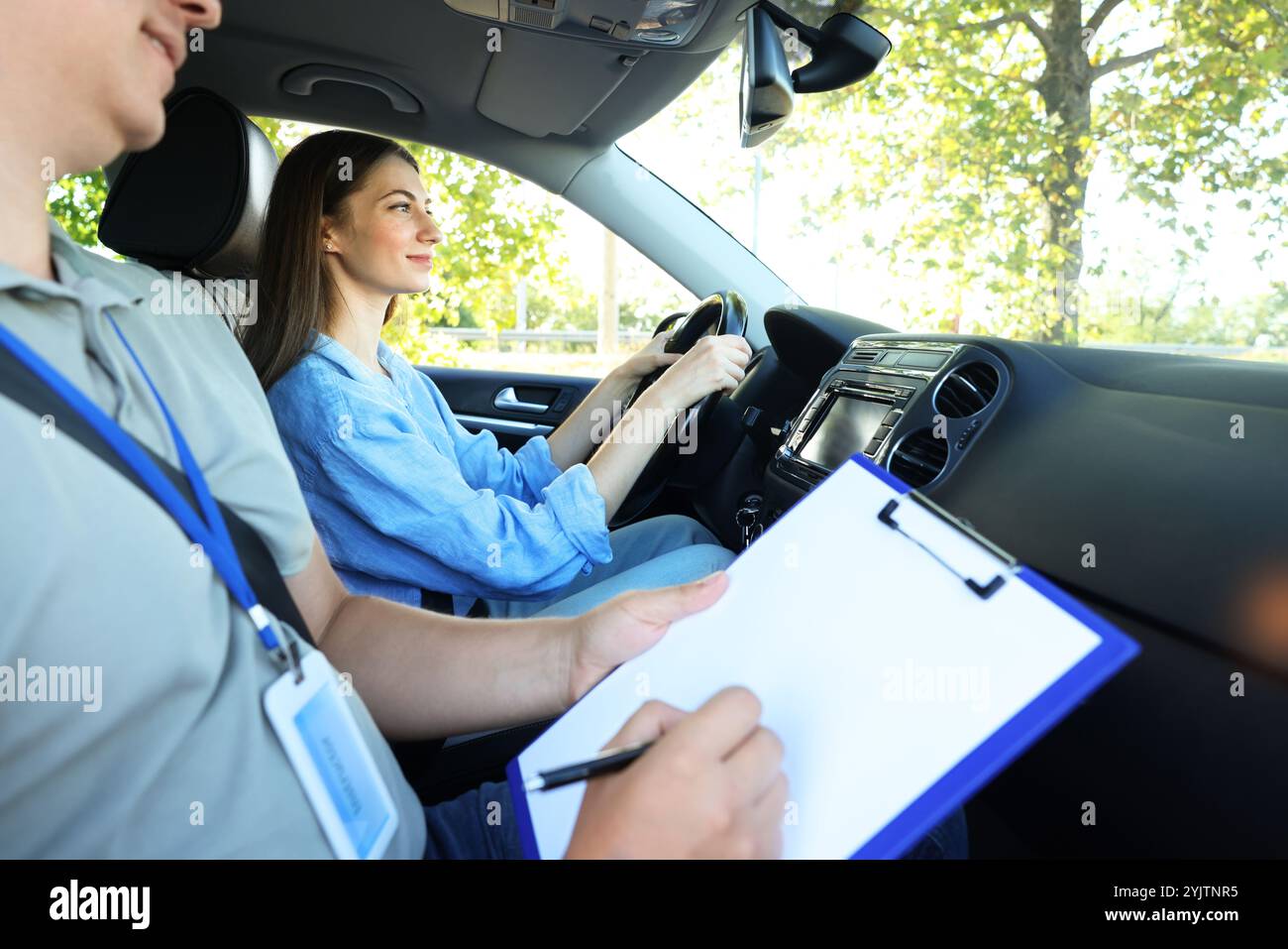 Driving school. Student passing driving test with examiner in car Stock ...