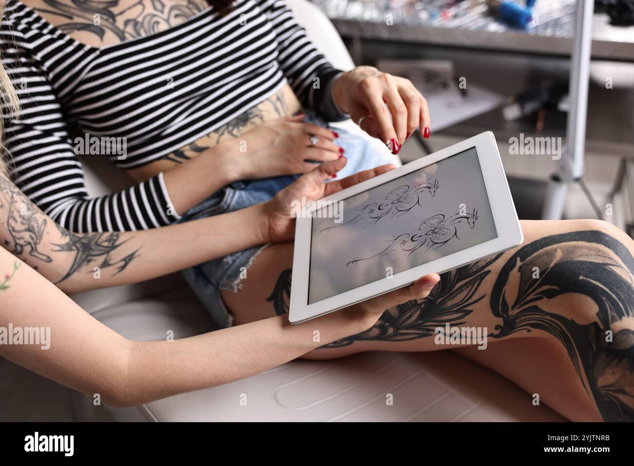 Tattoo artist showing tablet hi-res stock photography and images - Alamy
