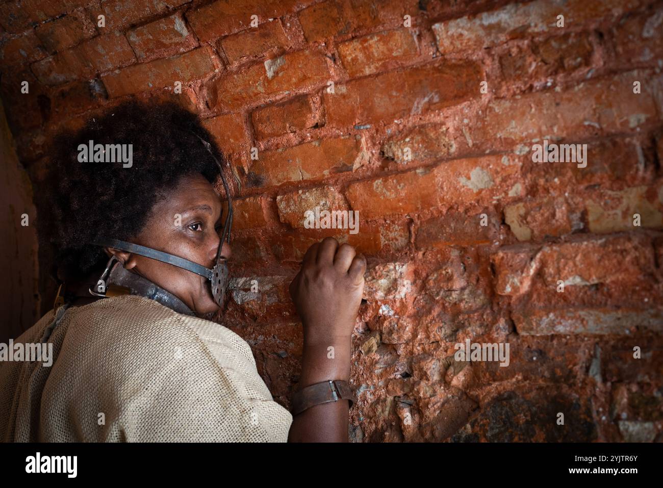 Portrait of a black woman chained and with an iron mask stuck in her ...