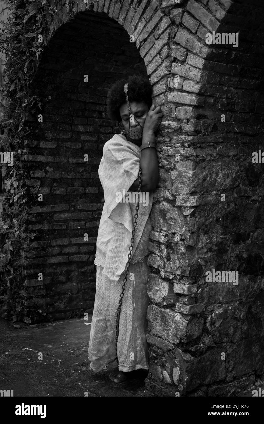 Black woman chained and with an iron mask stuck in her mouth, standing ...