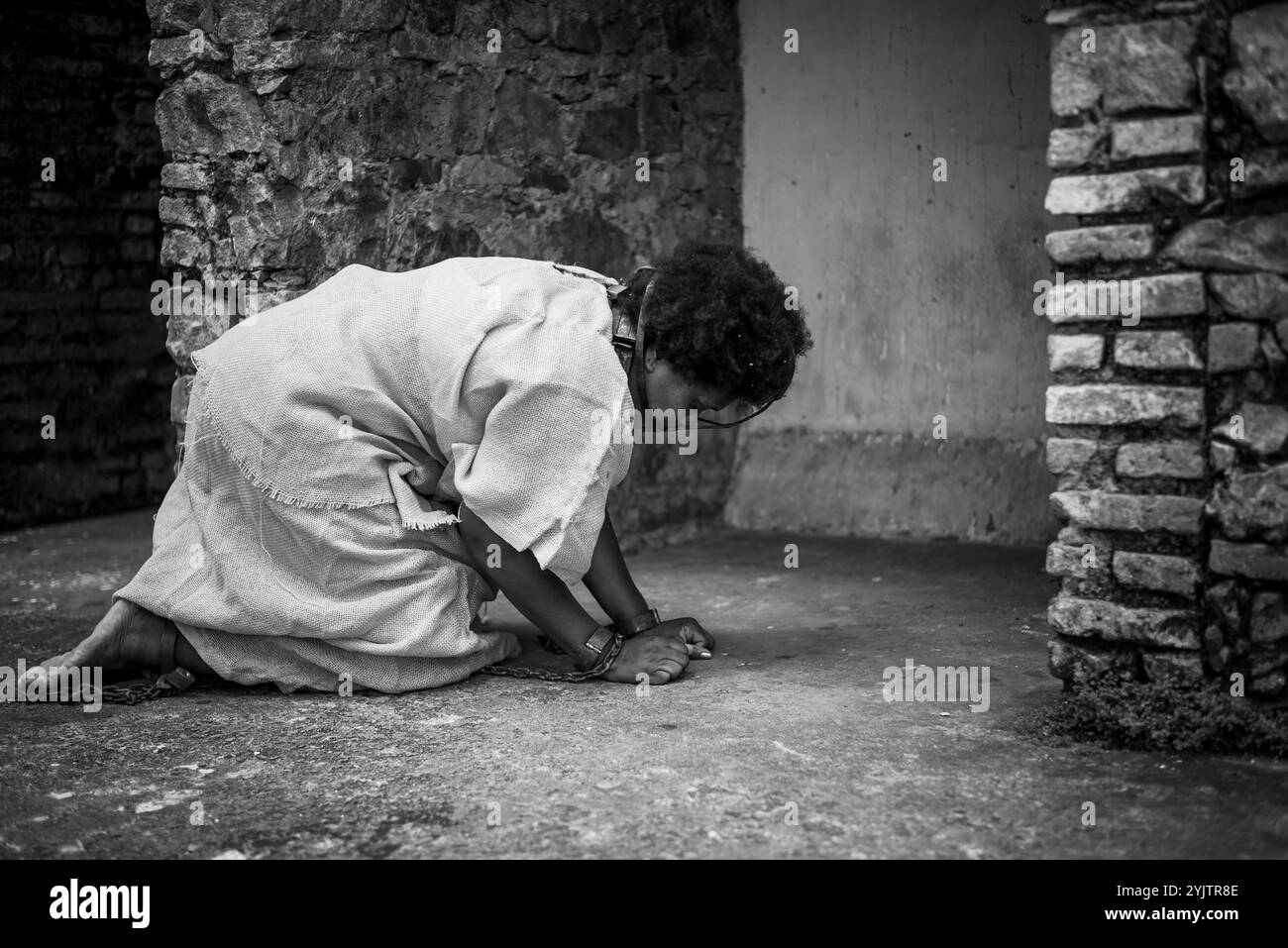 Black and white portrait of a black woman in chains, with an iron mask ...