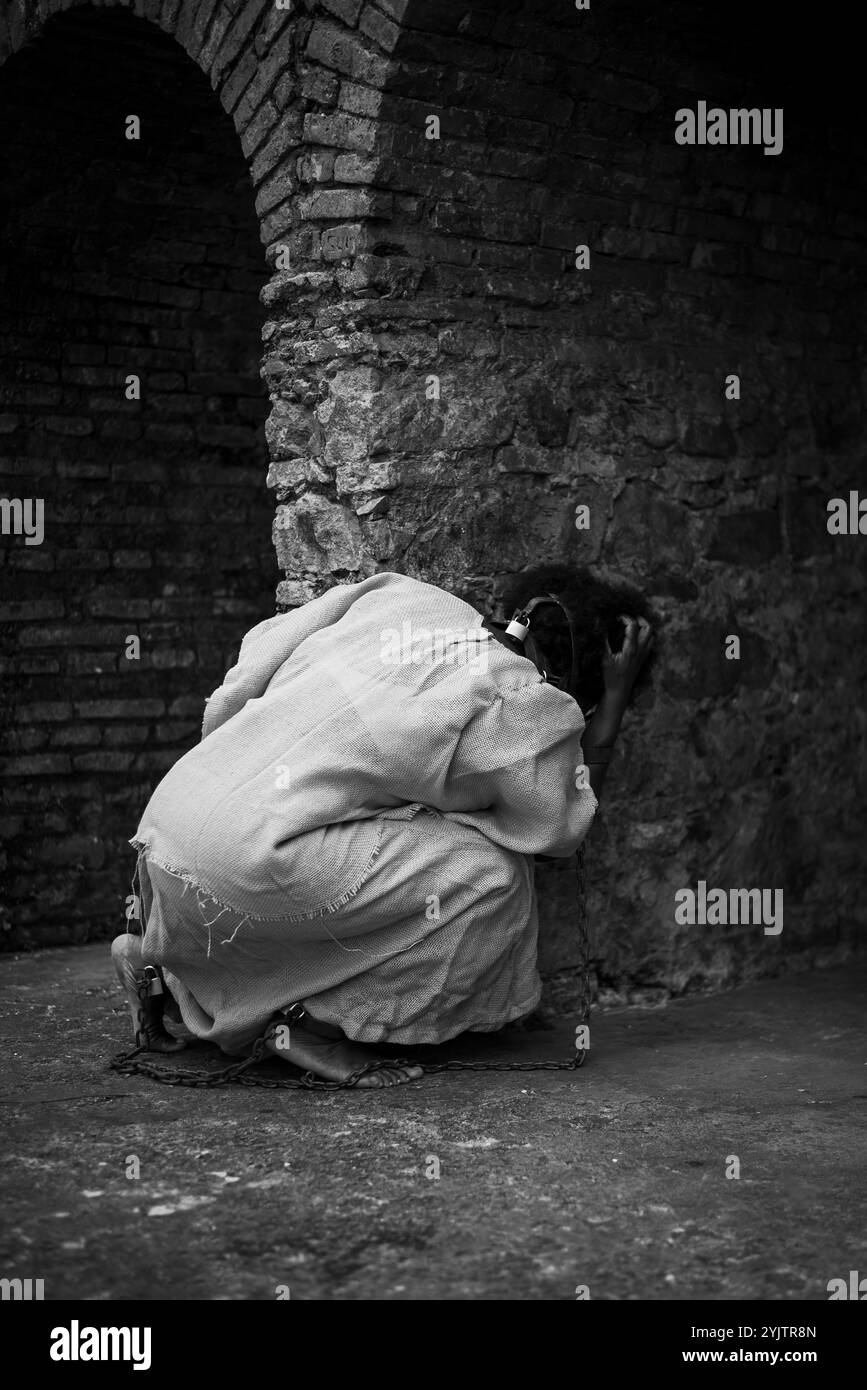 Black and white portrait of a black woman in chains, with an iron mask ...