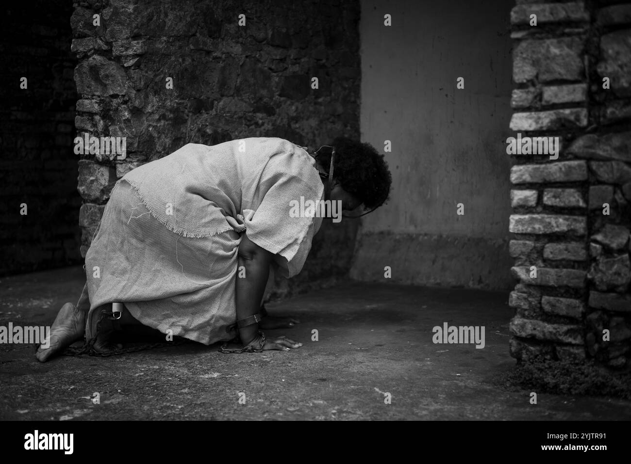 Black and white portrait of a black woman in chains, with an iron mask ...