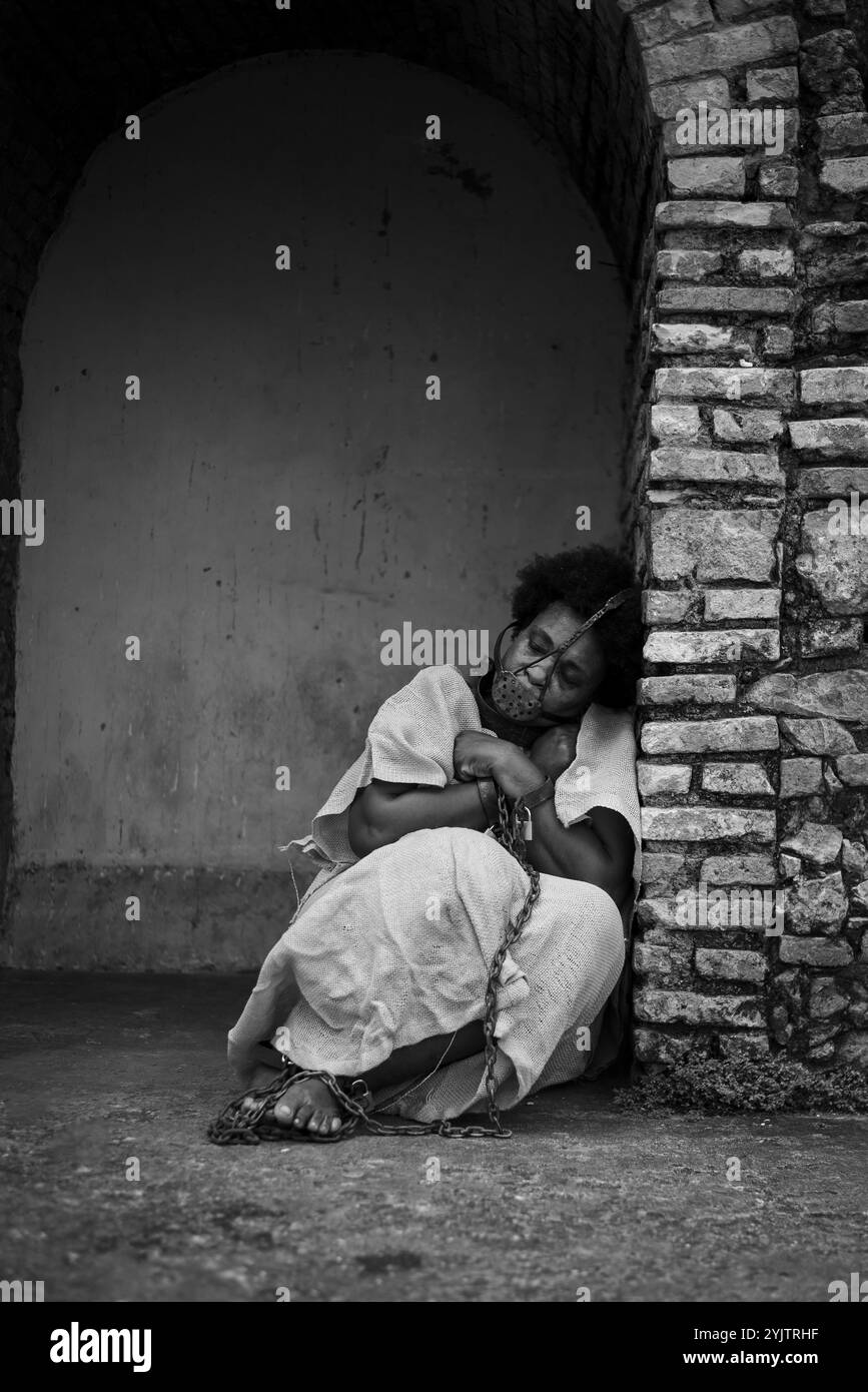 Black and white photo of a black woman with an iron mask over her mouth ...