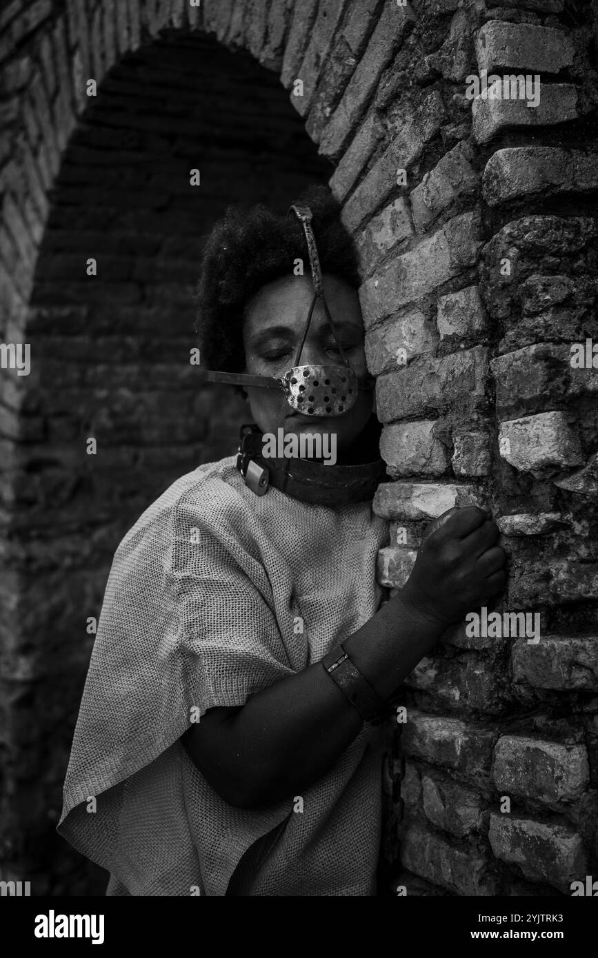 Black and white portrait of a black woman in chains and with an iron ...