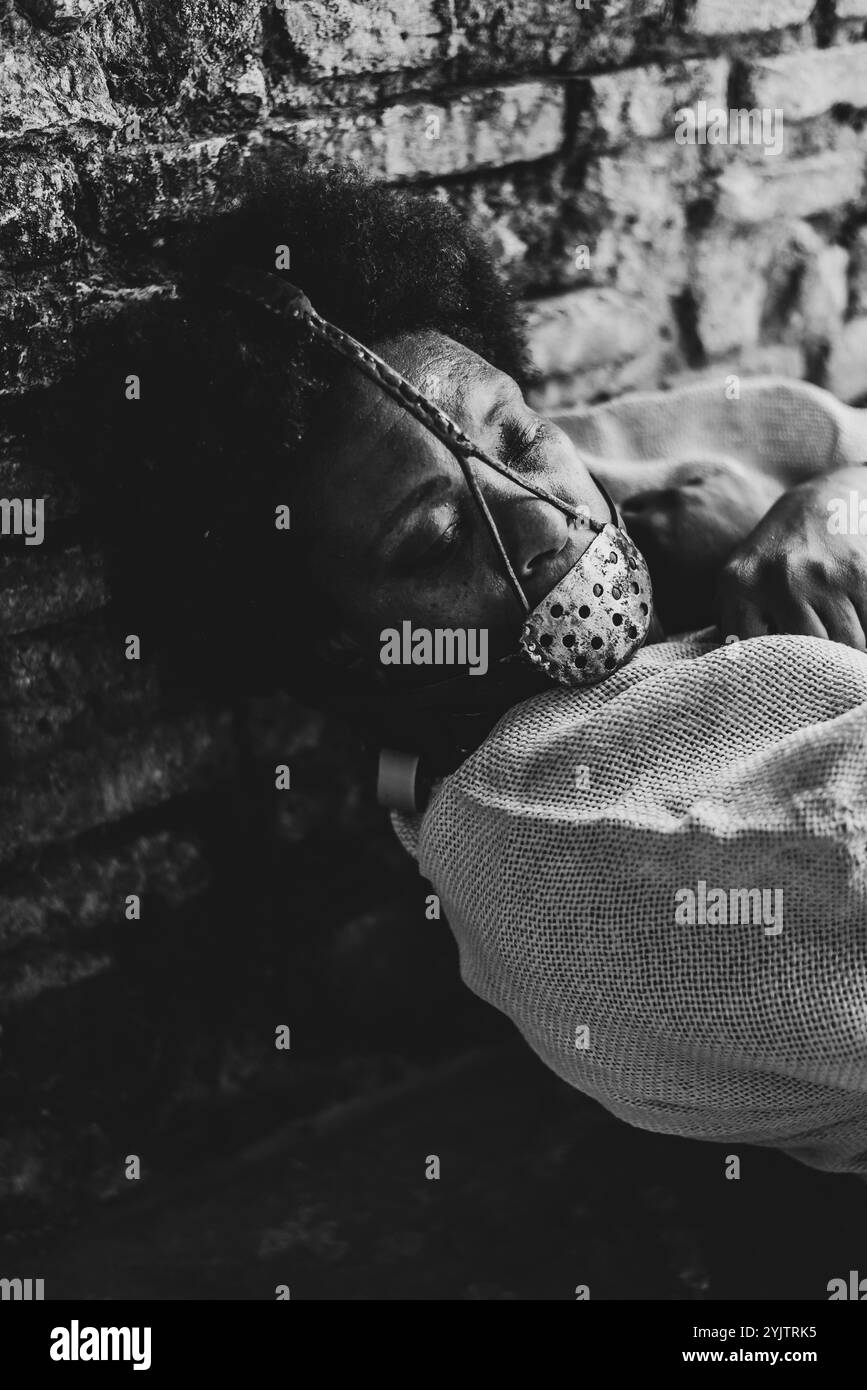 Black and white portrait of a black woman with an iron mask on her ...