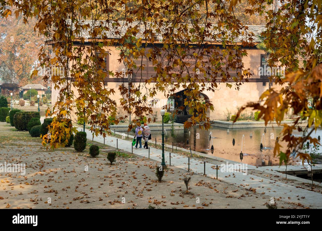 Visitors are seen walking inside a Mughal garden on a chilly autumn day ...