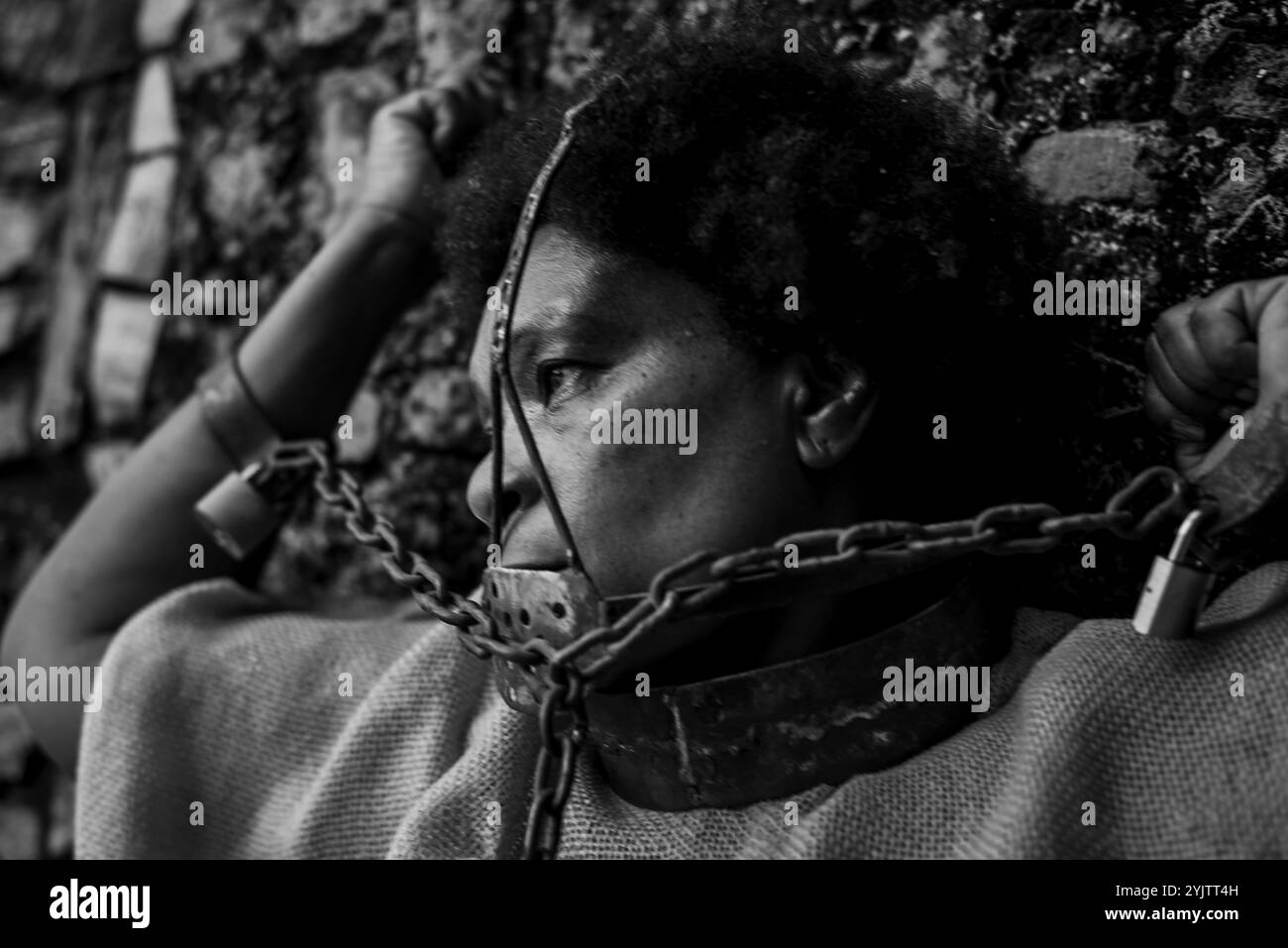 Portrait of a black woman's face with an iron mask stuck in her mouth ...