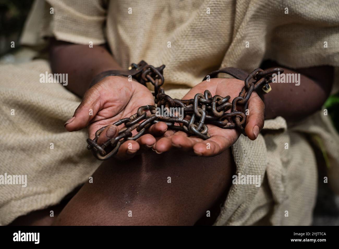 Portrait of a woman's hands in chains holding the chains. Slavery in ...