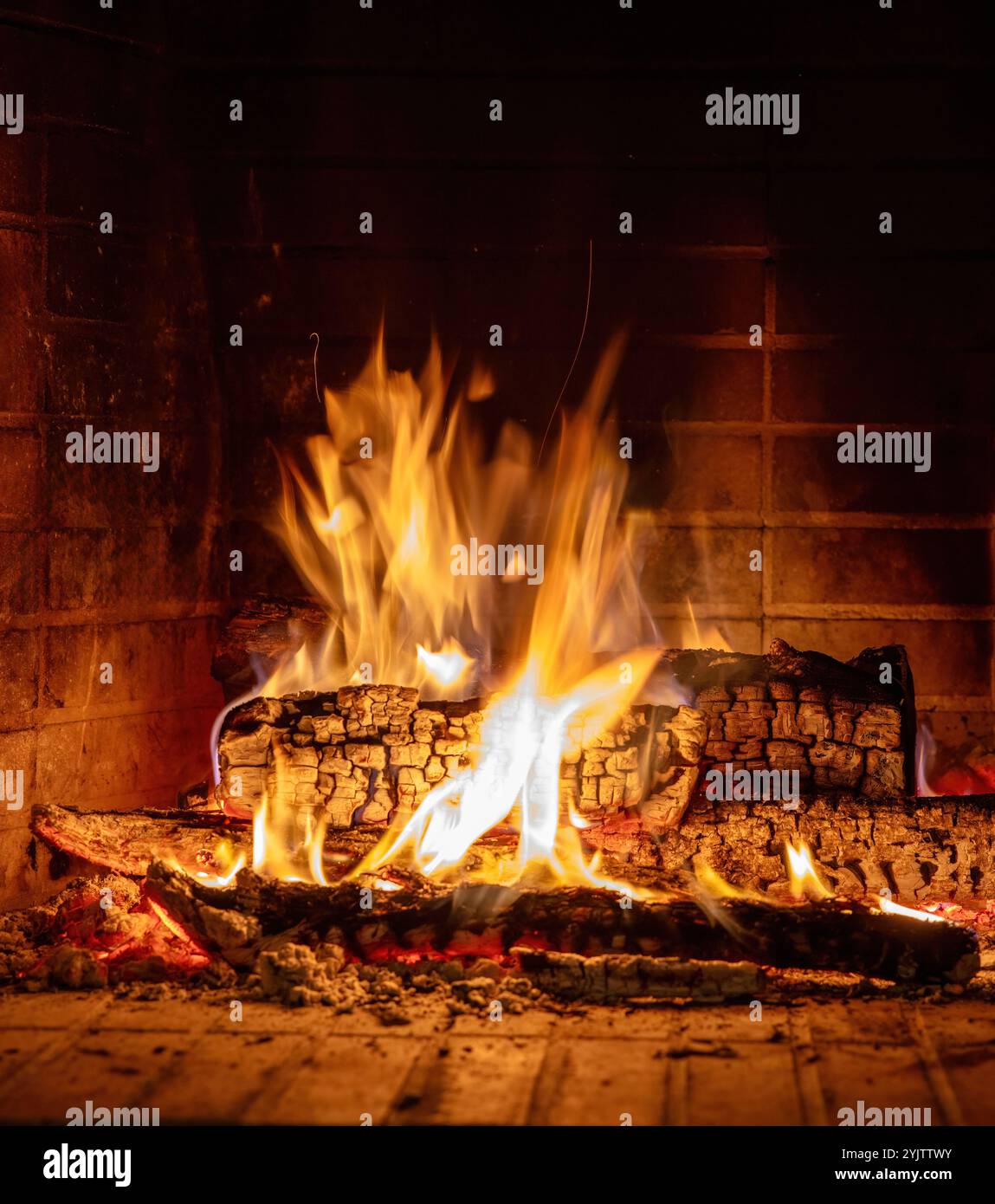 Fire flames, wood logs burning in fireplace. Warm home in winter, heat ...