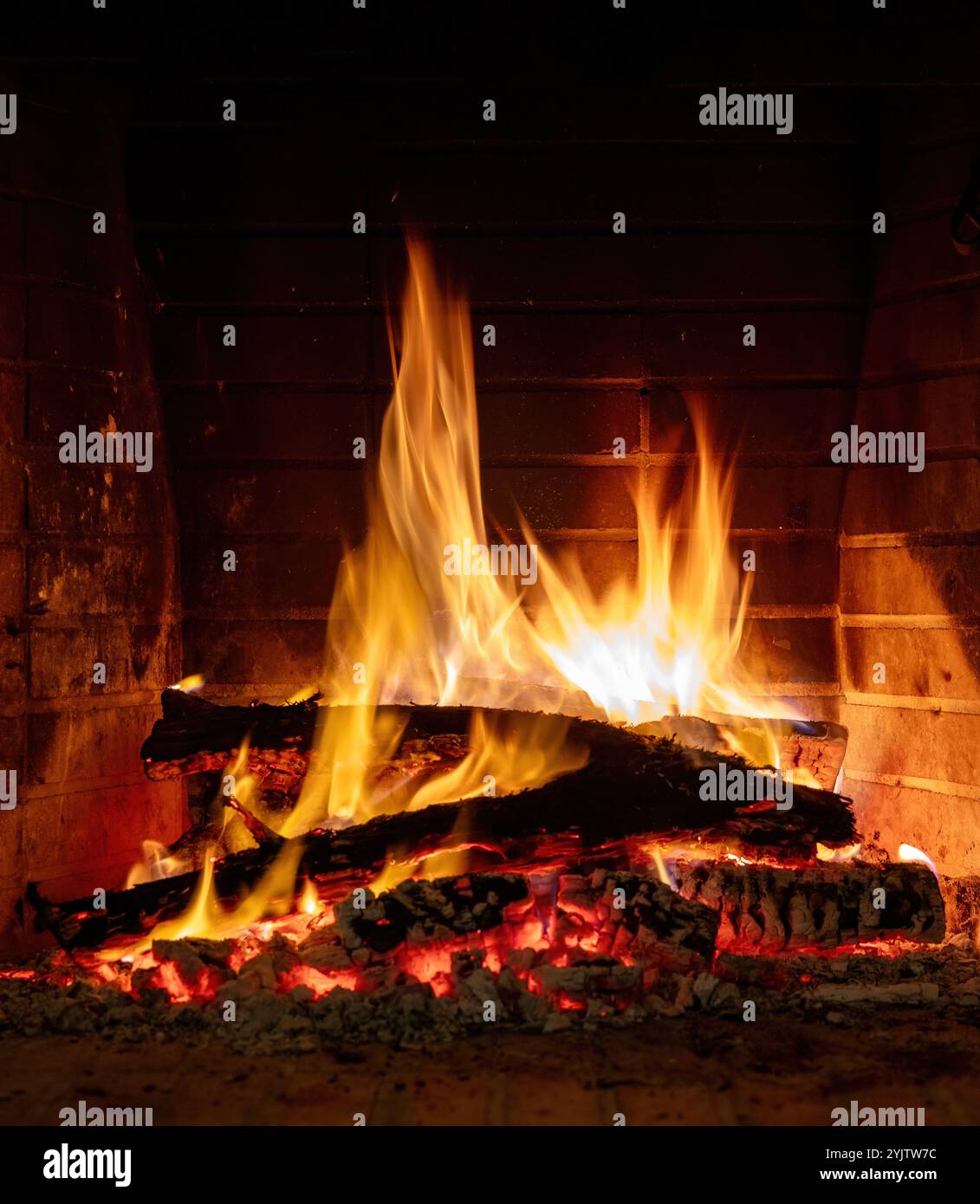 Fire flames, wood logs burning in fireplace. Warm home in winter, heat ...