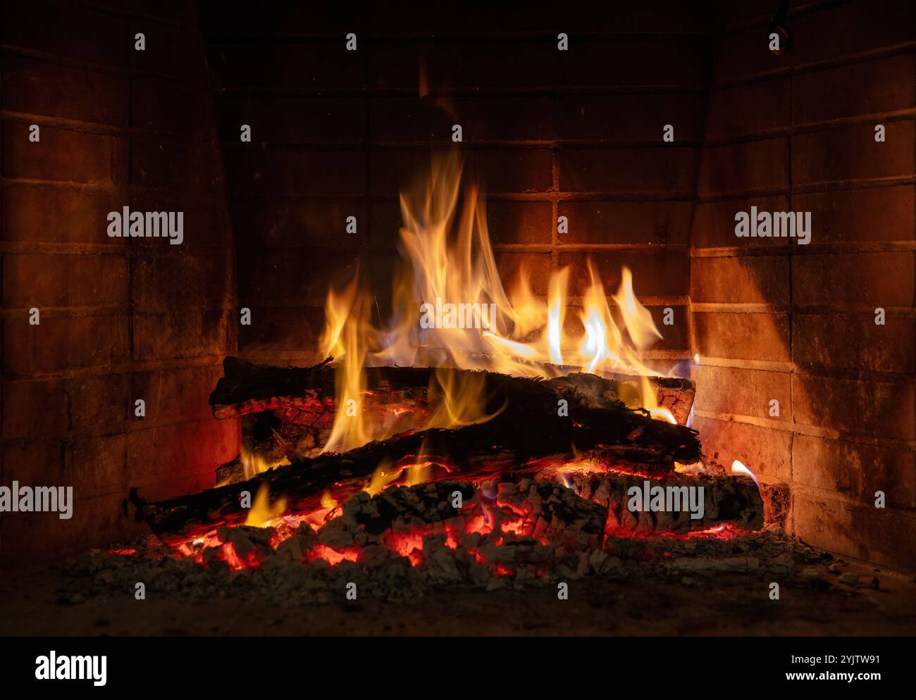 Fire flames, wood logs burning in fireplace. Warm home in winter, heat ...