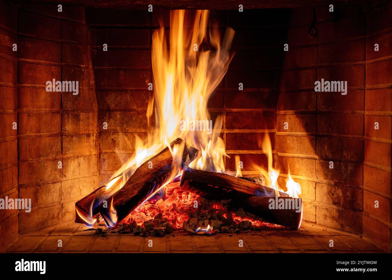 Fire flames, wood logs burning in fireplace. Warm home in winter, heat ...