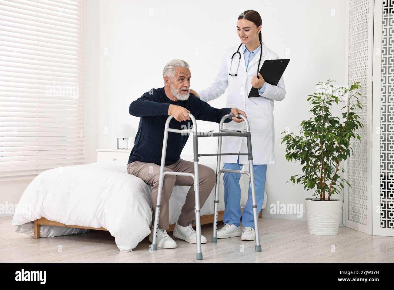 Doctor helping disabled man rehabilitation hi-res stock photography and ...