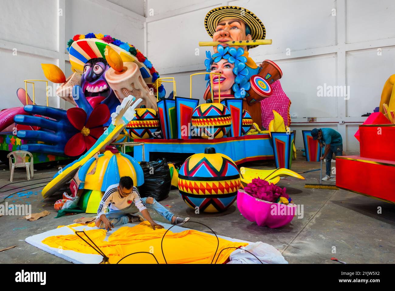 A Colombian artisan works on the elements of an allegorical float at ...