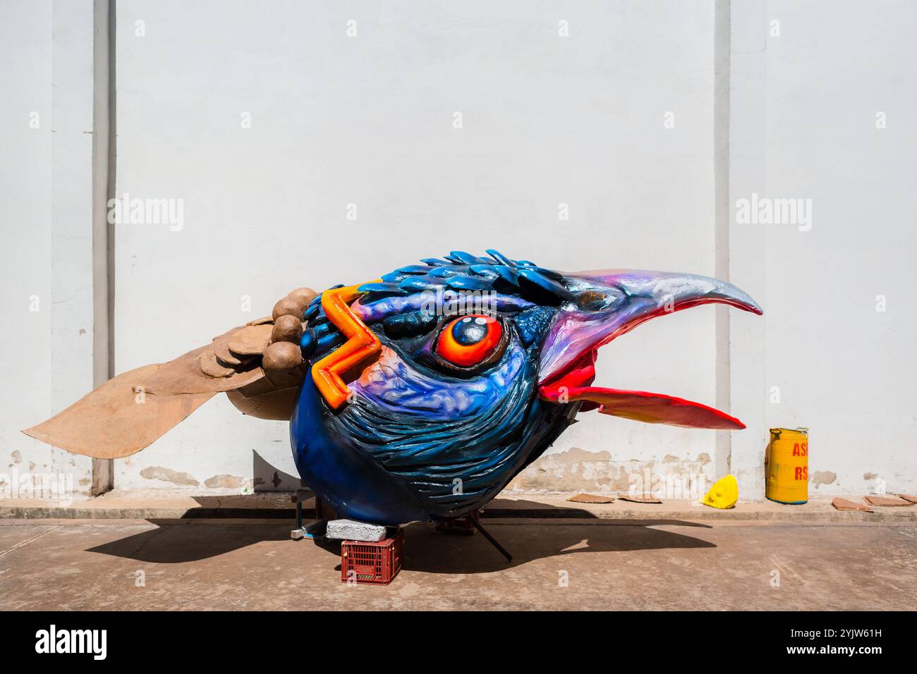 A freshly painted paper-mâché sculpture of a parrot's head is seen ...