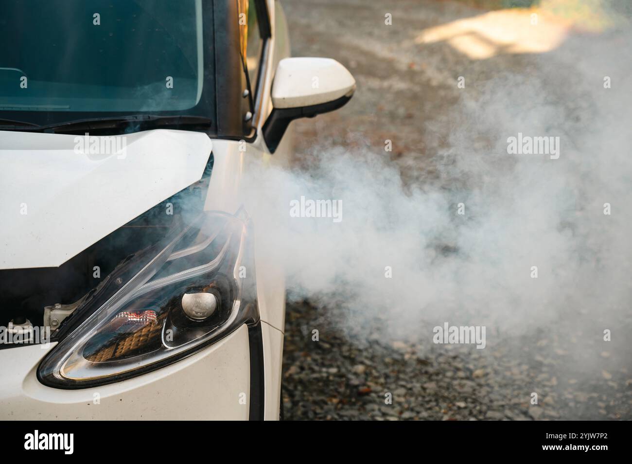 Smoke is coming from under the hood of the car Stock Photo - Alamy