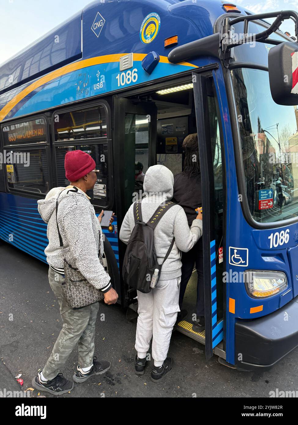 People getting on a city bus in Brooklyn, New York Stock Photo - Alamy