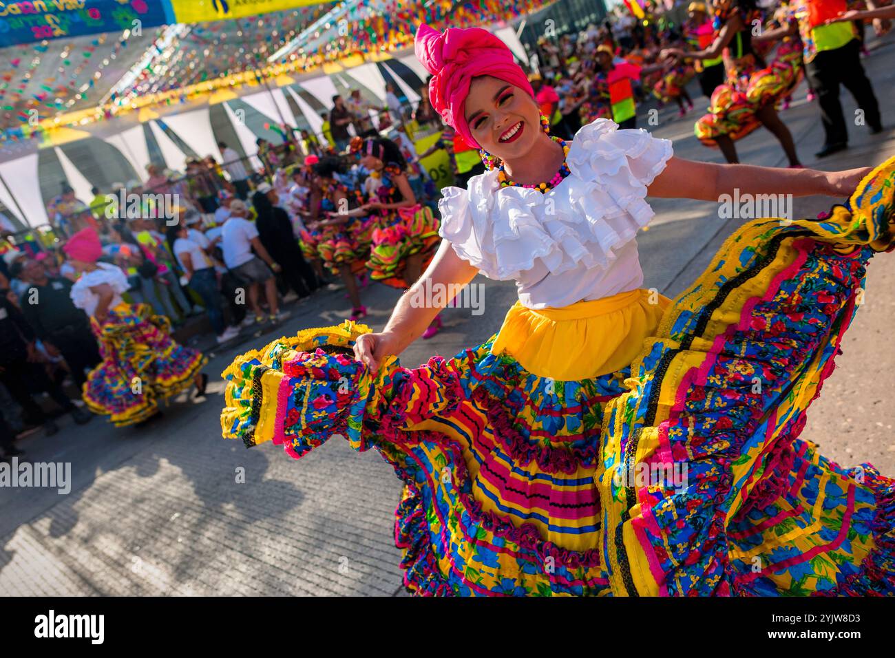 A Colombian woman, twirling a traditional cumbia skirt, dances the ...