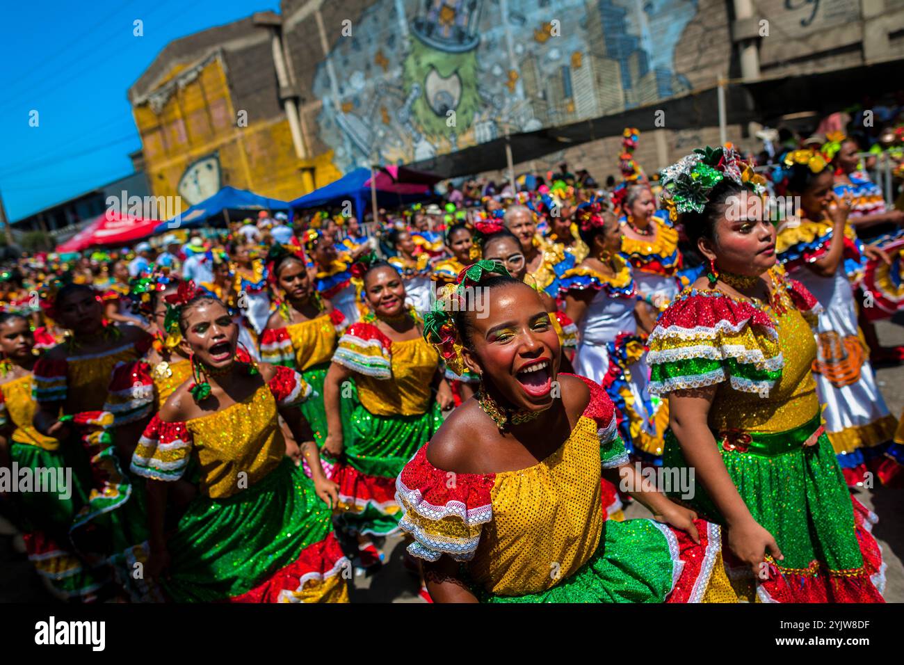 Afro-Colombian women, wearing traditional cumbia outfits, dance the ...