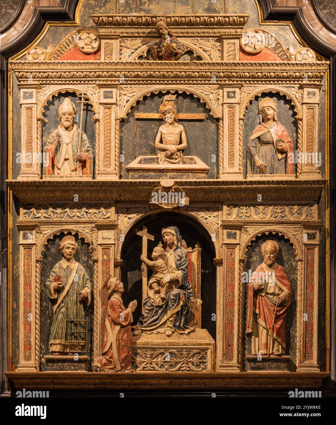 Pavia - The carved polychrome renaissance altar with the Madonna and ...