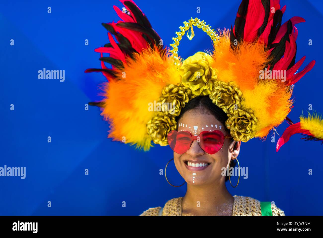 A Colombian dancer, wearing a feathered headband, takes part in the ...