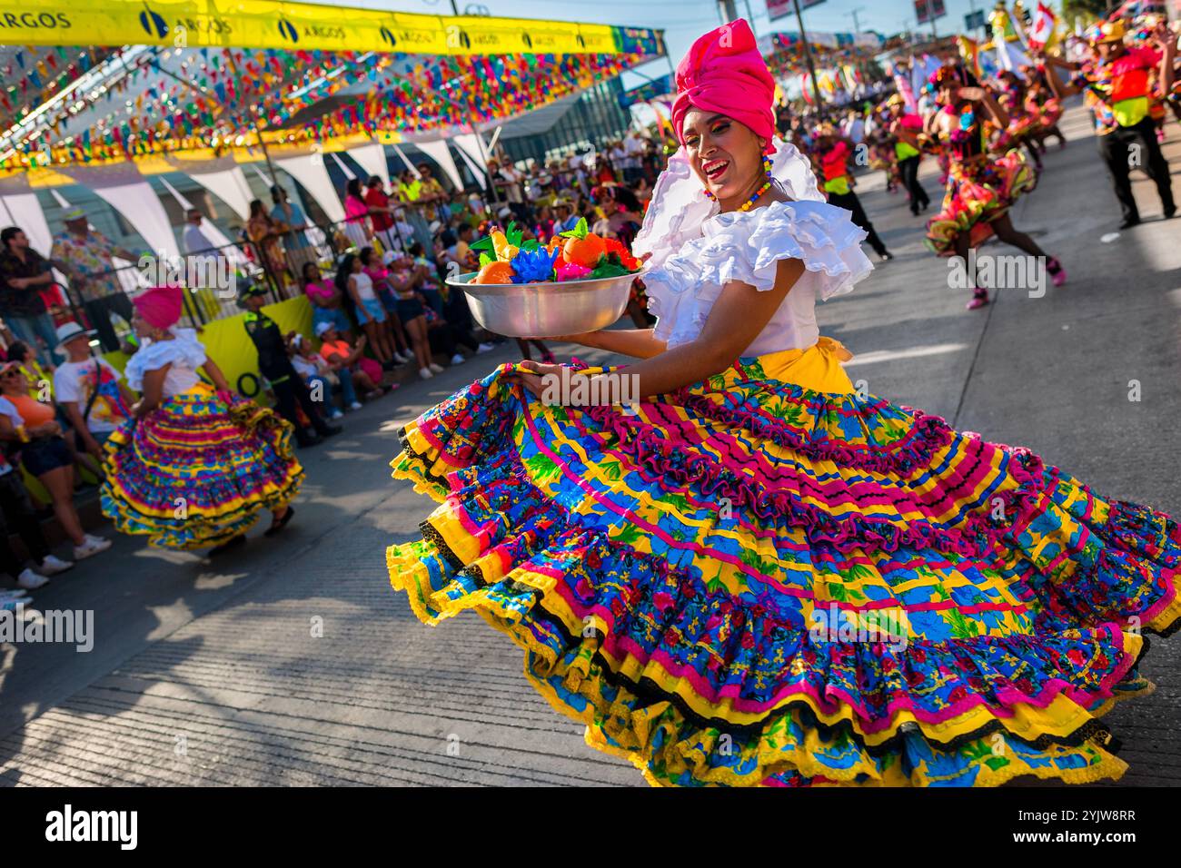 A Colombian woman, wearing a traditional cumbia outfit, dances the ...