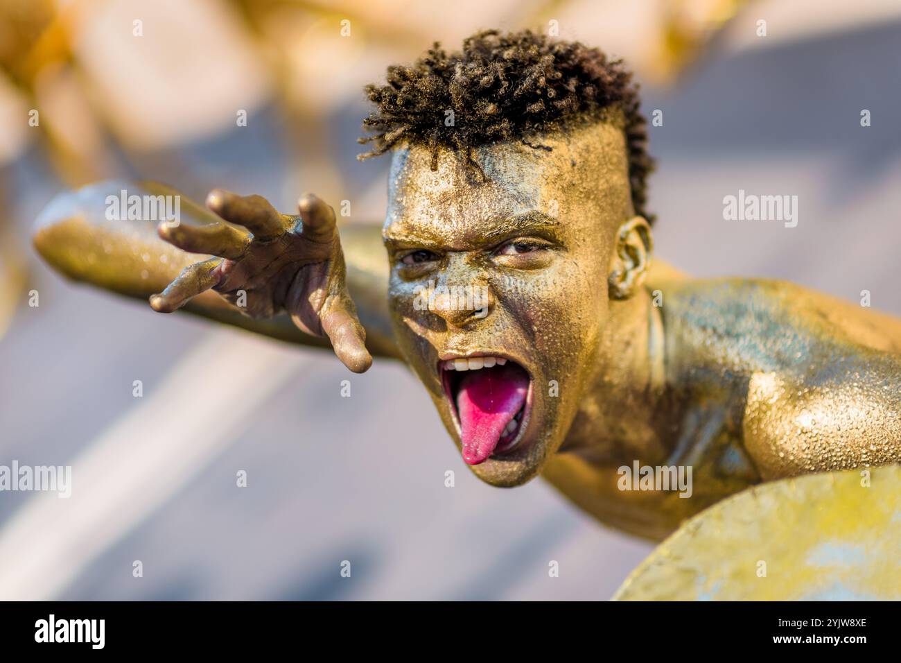 A Colombian man, painted in gold and representing the original ...