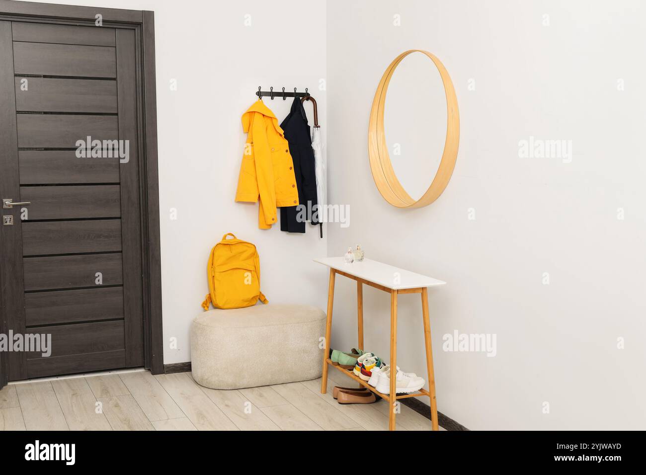 Mirror, rack with clothes and shoe storage bench in hallway. Interior ...