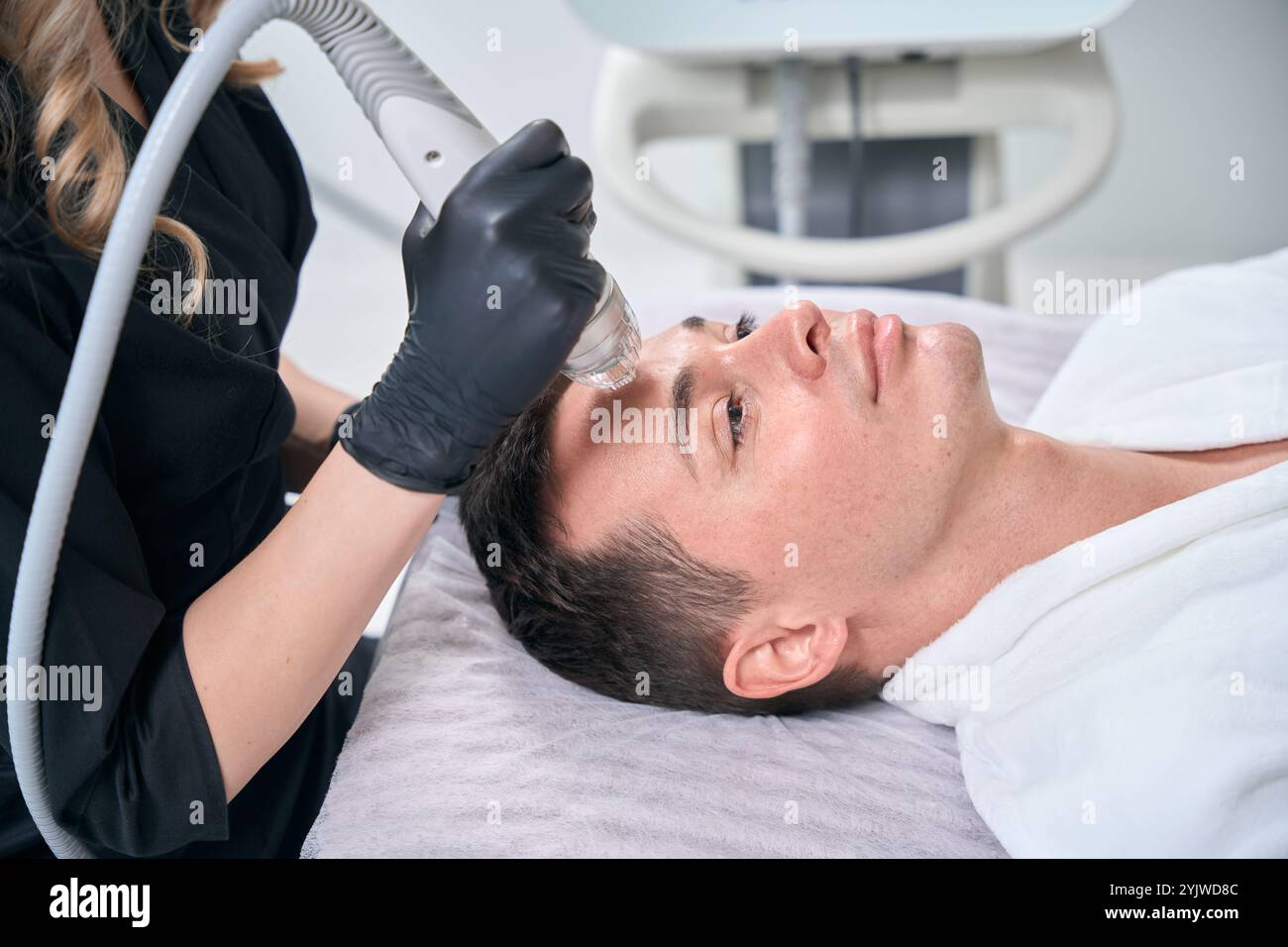 Man attending microneedle rf lifting procedure in aesthetic cosmetology ...