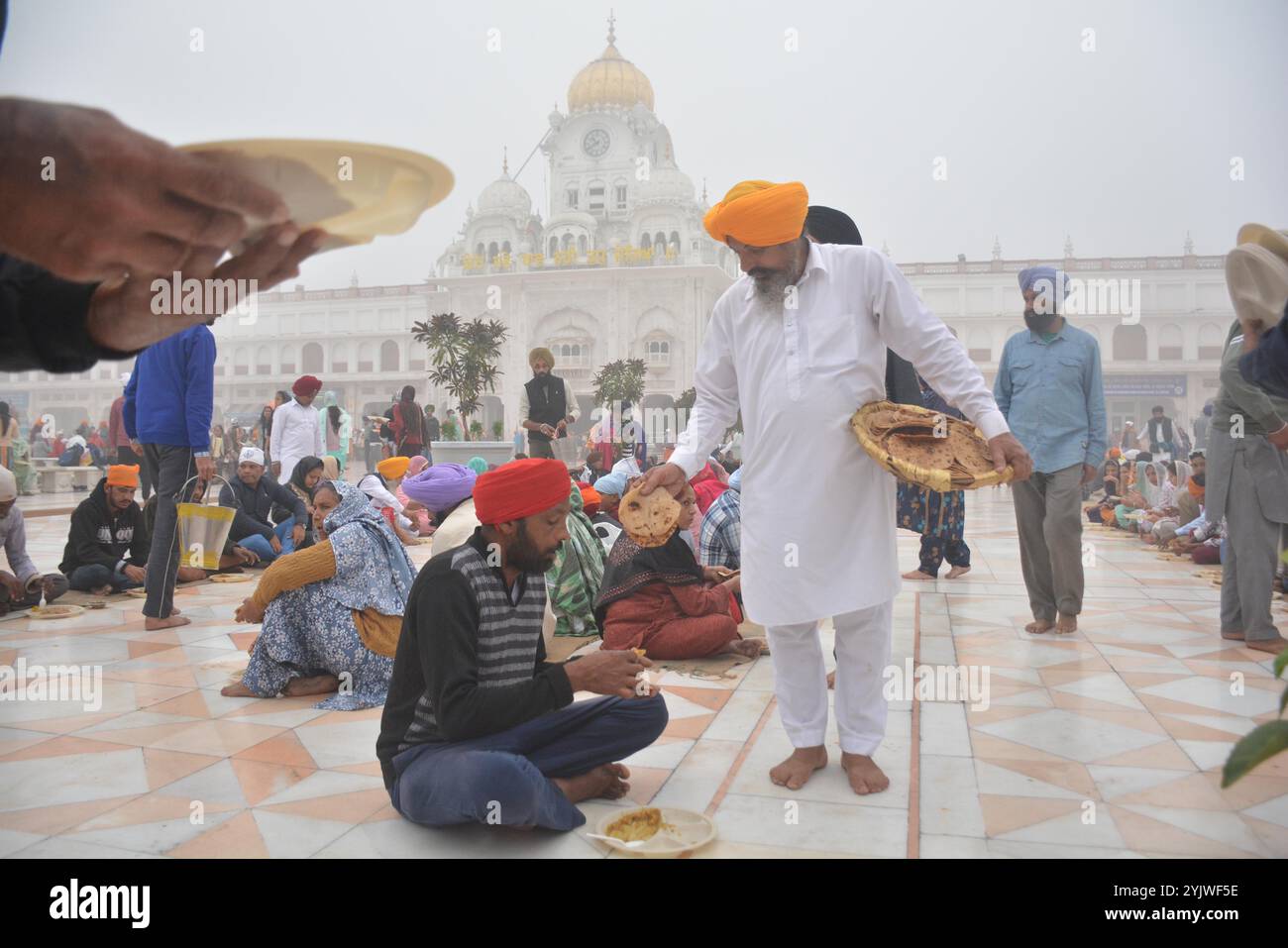 AMRITSAR, INDIA - NOVEMBER 15: Devotees partaking of langar on the ...