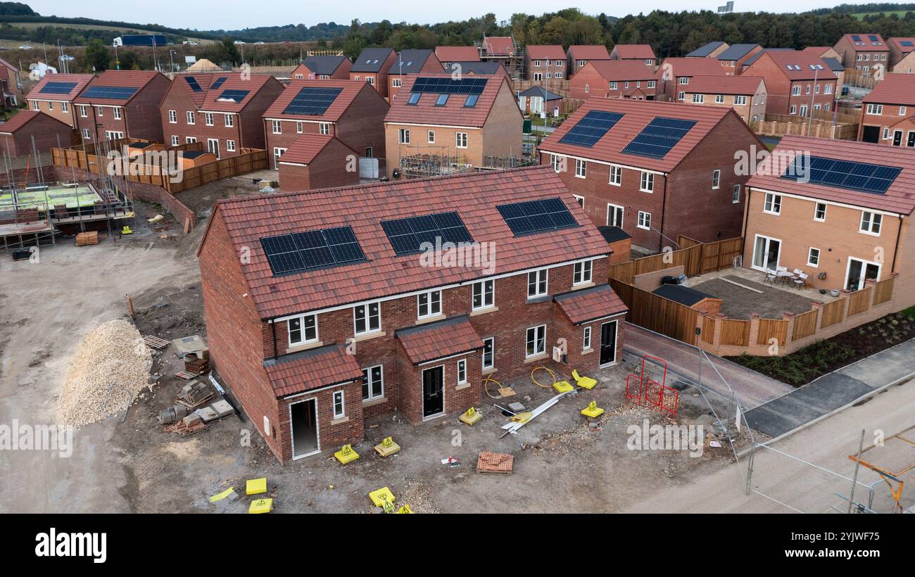 The roof of a row of new build houses on a construction site under ...