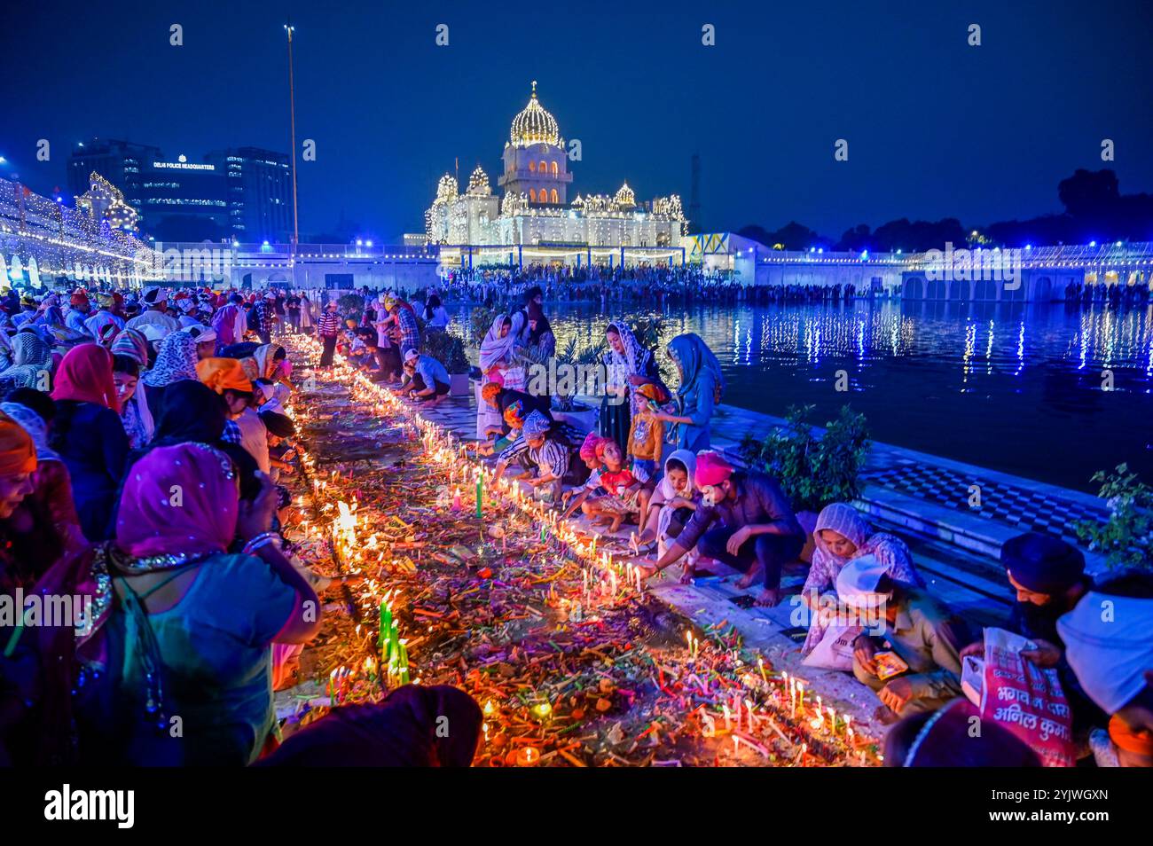 NEW DELHI, INDIA - NOVEMBER 15: Devotees seen lighting the candles on the occasion of 555th Guru ...