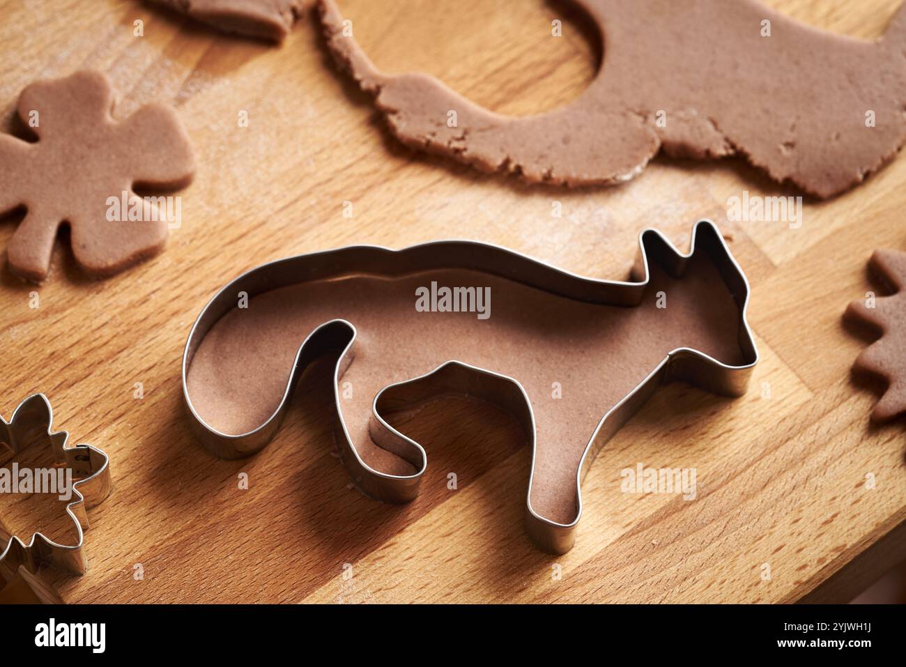 Cutting out a fox shape from raw pastry dough - preparation of homemade ...
