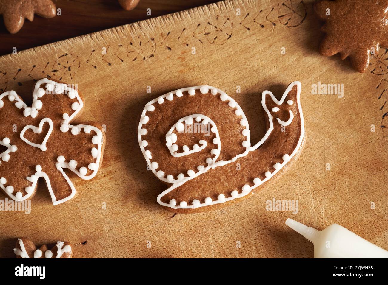 Snail shaped homemade gingerbread Christmas cookie decorated with white ...