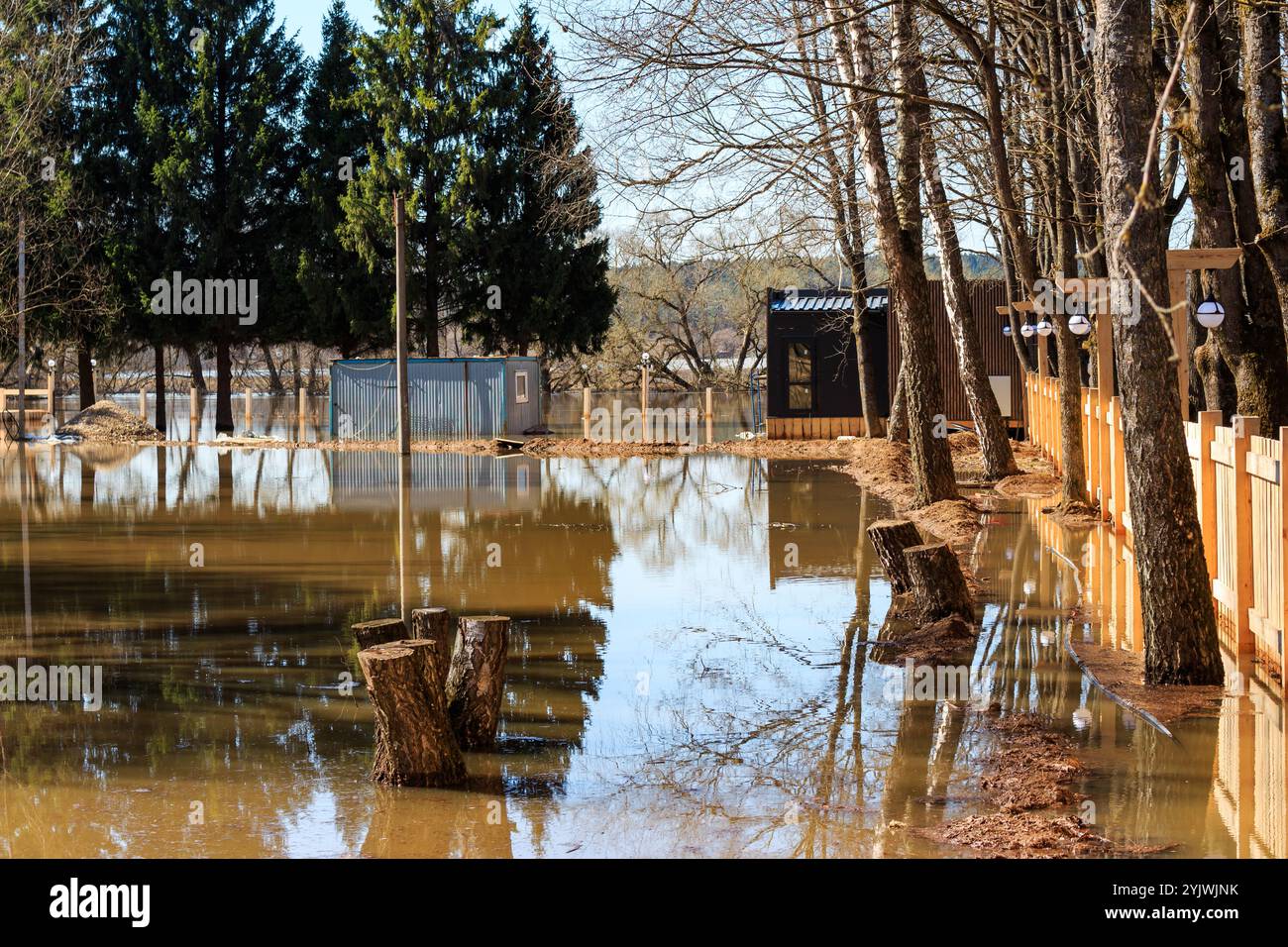 Rising water level in the river floods the area on the bank Stock Photo ...